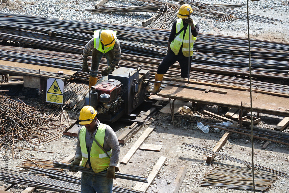 Construction workers working at the steel reinforcement bar bending ...