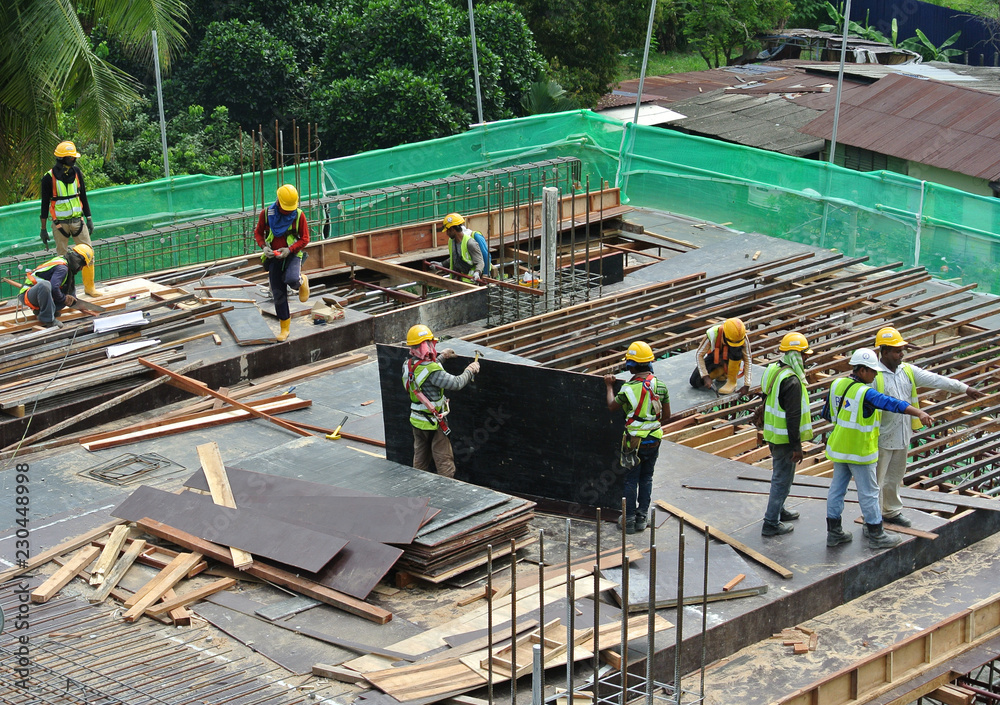 Construction workers working at the construction site at Seremban ...
