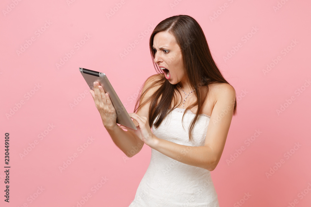 Aggressive angry bride woman in wedding dress screaming working on ...