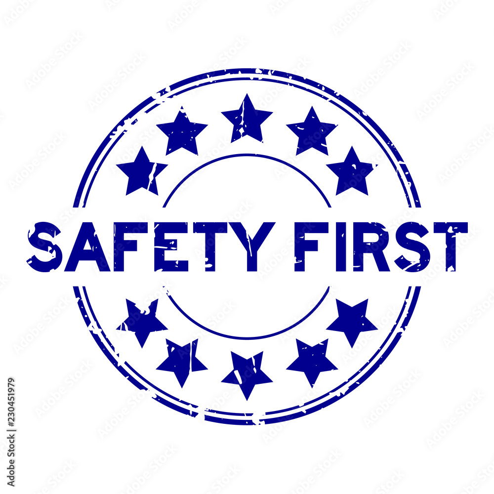 Grunge blue safety first wording with star icon round rubber seal stamp ...