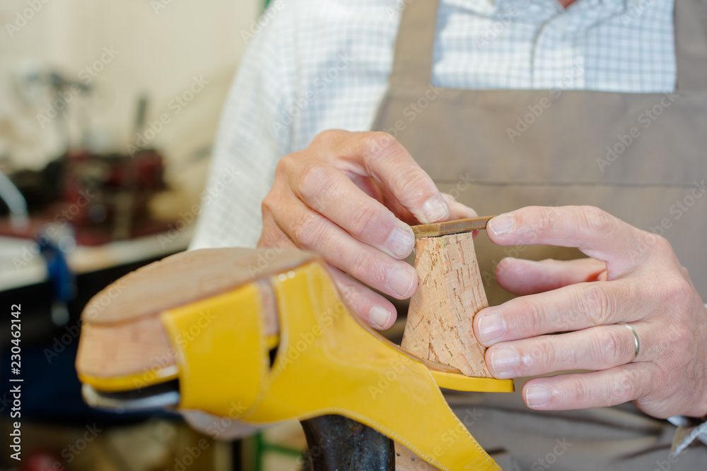 fixing a sandal's heel Stock Photo | Adobe Stock
