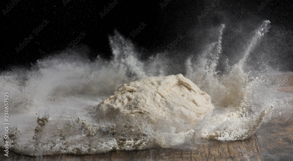 Studio close-up photo of a ball of dough falling on flour Stock Photo ...