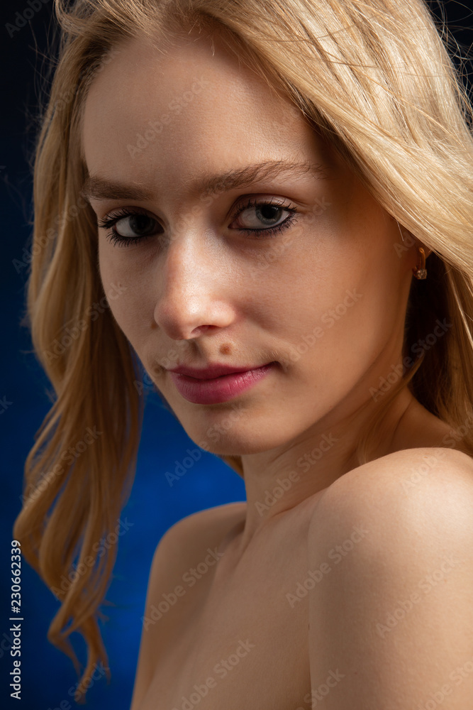 sad beautiful blonde transgender with bare shoulders looking at camera ...
