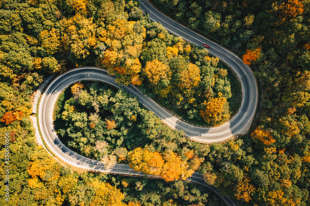 Extreme curved winding road in the forest aerial photography Stock ...