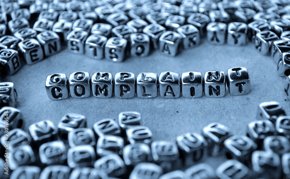 Complaint - Word from Metal Blocks on Paper - Concept Photo on Table ...