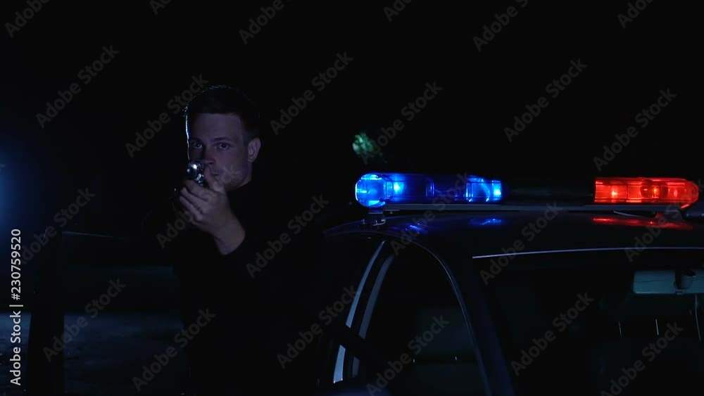 Police officer near car aiming gun at bank robbery scene, cops and ...