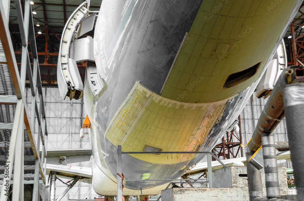 Passenger aircraft on maintenance and fuselage repair after damage in ...
