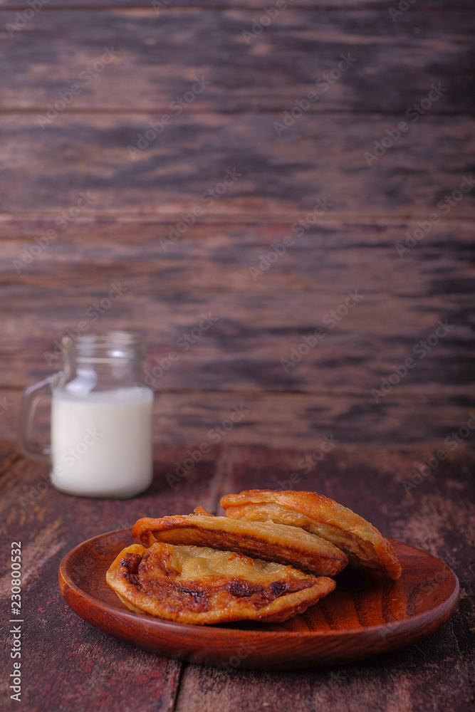 Akok Kedut on wooden plate over the wooden table. Akok Kedut is a ...