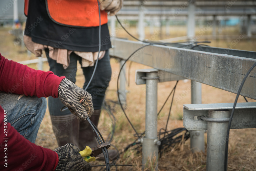 engineer and electrician installing solar power plant; scope of work at ...