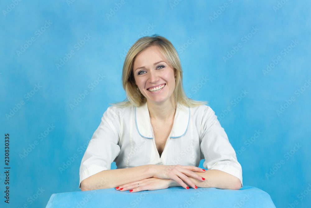 Girl lab technician on a blue background. Woman in a white lab ...