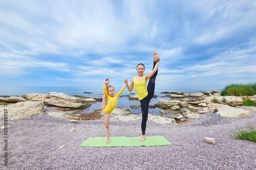 Healthy life education by example - woman and little girl exercising ...