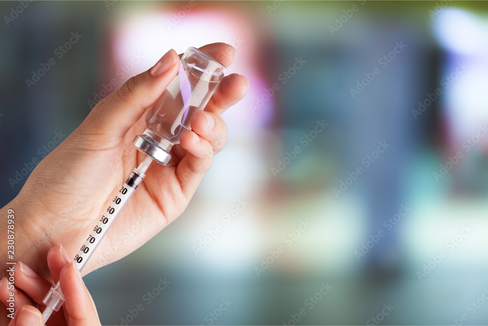 Human Hands with injection Syringe, on blurred Stock Photo | Adobe Stock