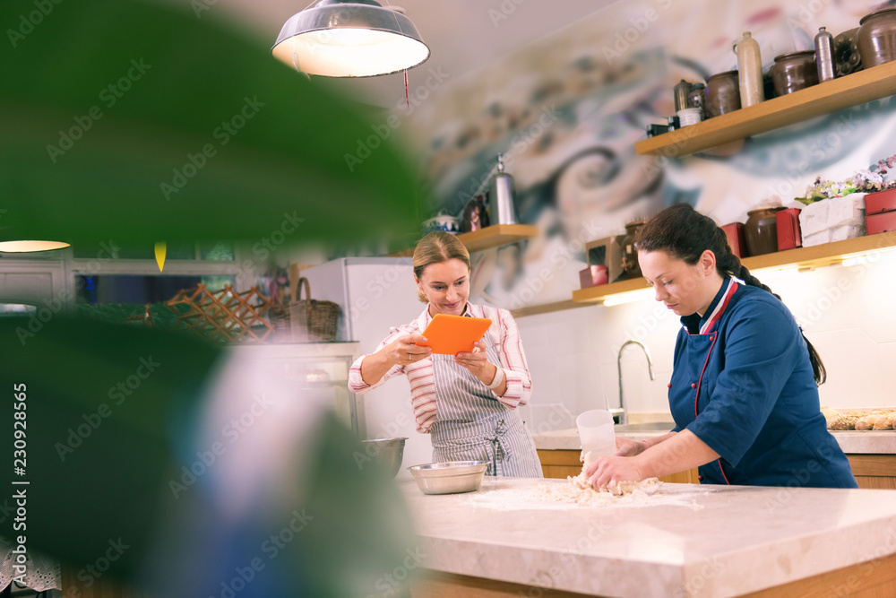 Video of employee. Beaming prosperous entrepreneur making video of her ...