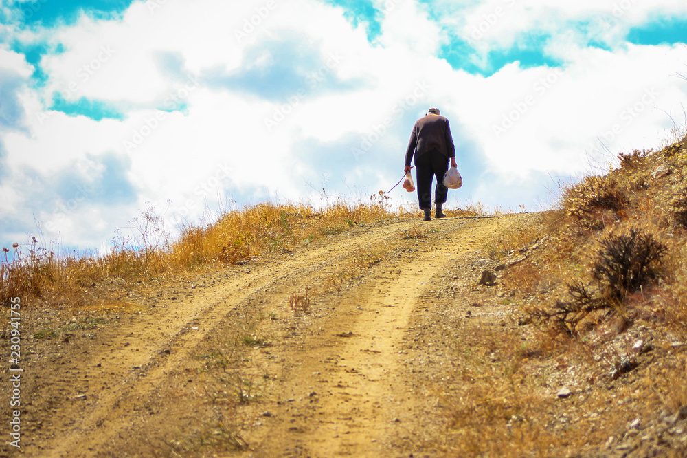 old man walking on country road Stock Photo | Adobe Stock
