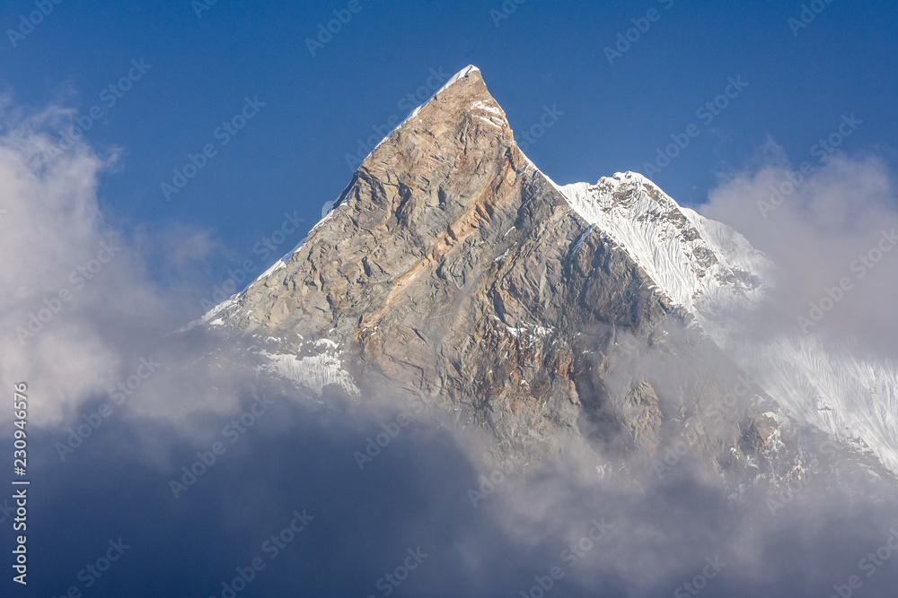 Fish Tail Summit ( Machapuchare) surrounded by rising clouds in the ...