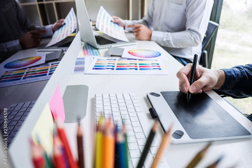 Two colleague creative graphic designer working on color selection and ...