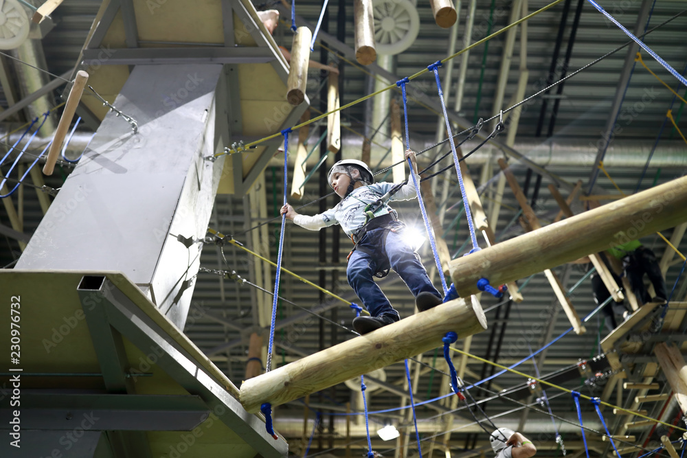 Kid climbing in rope park Stock Photo | Adobe Stock