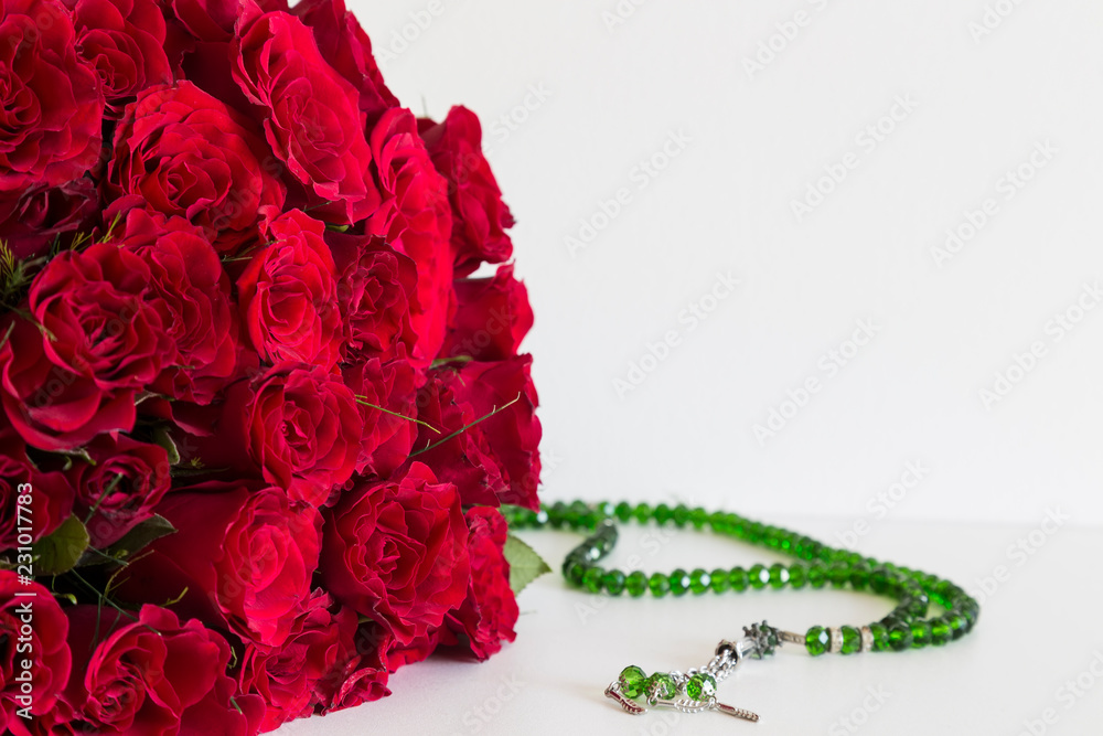 rosary beads and red roses on the white background for Islamic concept ...