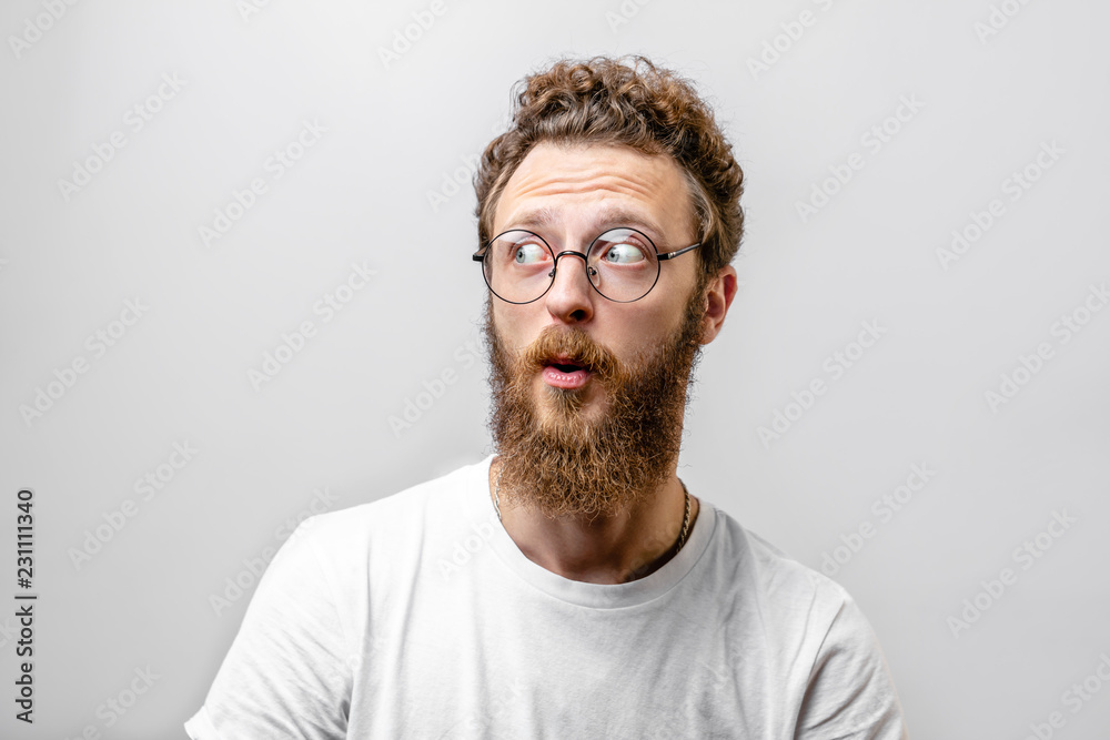 Emotional surprised bearded man looks with bated breath and shocked ...