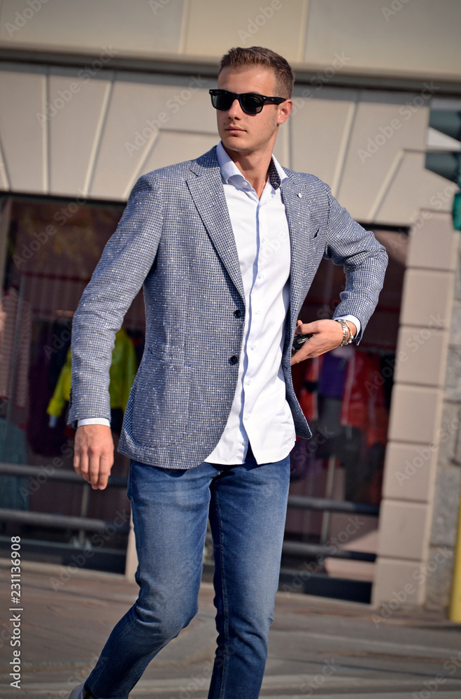 Urban young model man walking on street wearing sunglasses. Stock Photo ...