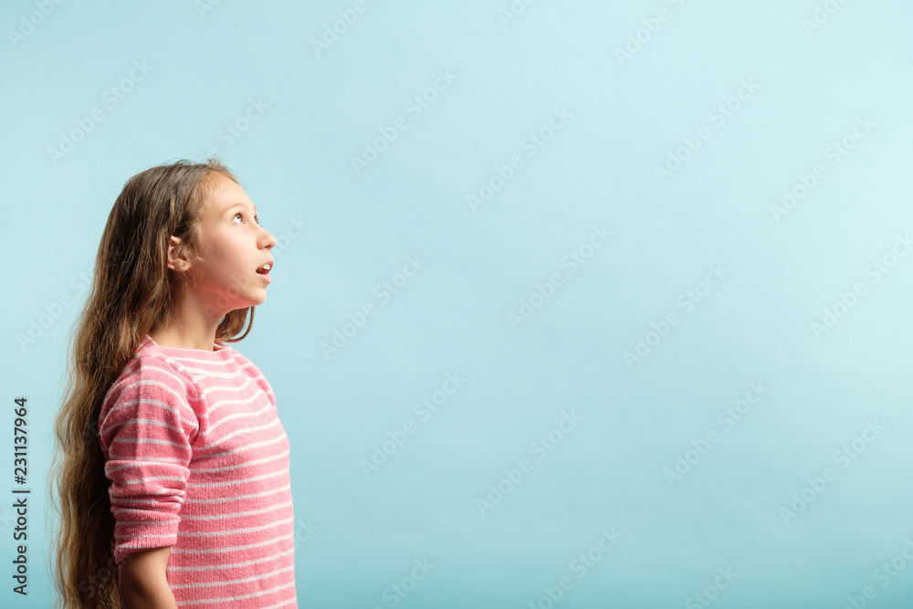 amazed shocked young girl looking up at a virtual object or text speech ...