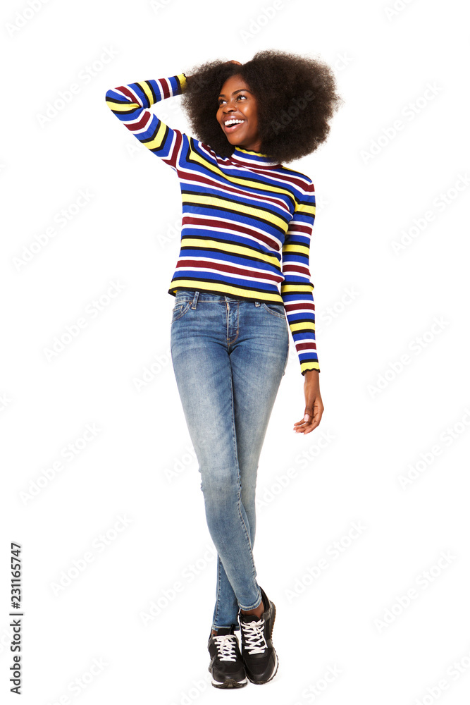 Full body smiling young black woman with hand in afro hair posing ...