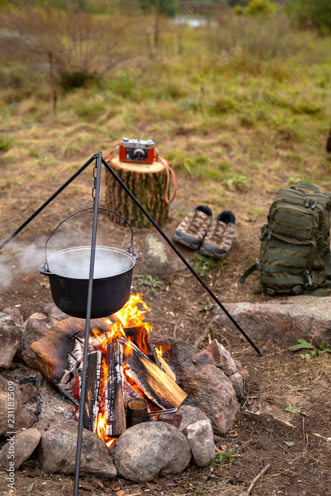 Cooking on a fire. Fish soup on a fire. Food in a cauldron on a fire ...