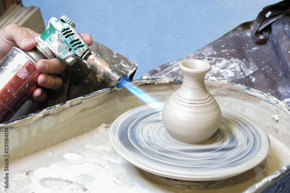 pottery creating and burning a clay pot with a gas burner on pottery ...
