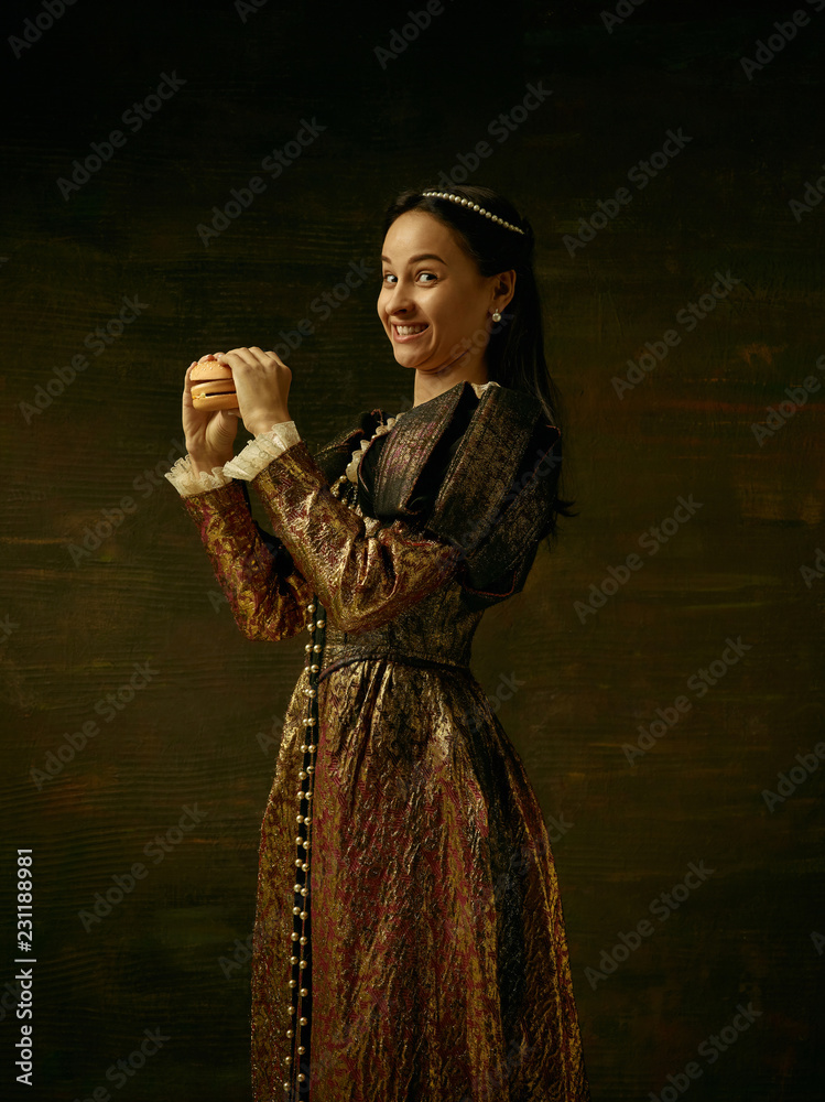 Girl in medieval beautiful dress or costume of the countess at dark ...