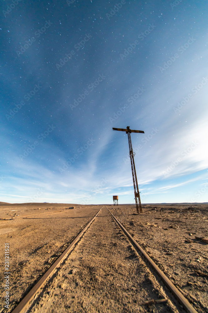 Old and abandoned railway track and station with it water tank to fill ...