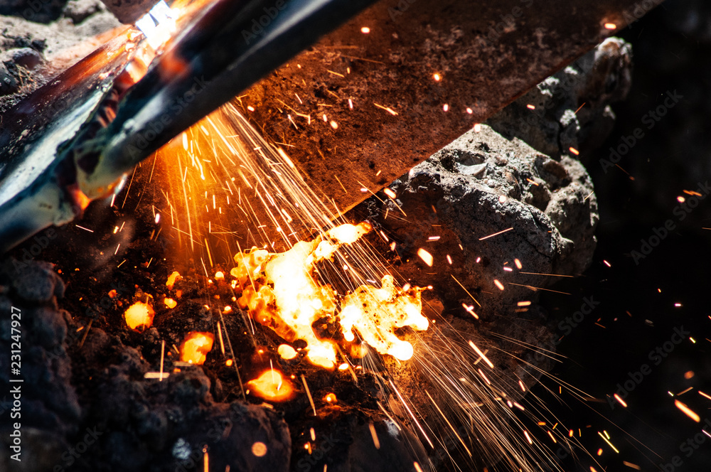Molten metal flying from cutting torch, sparks, metal and cement. Stock ...