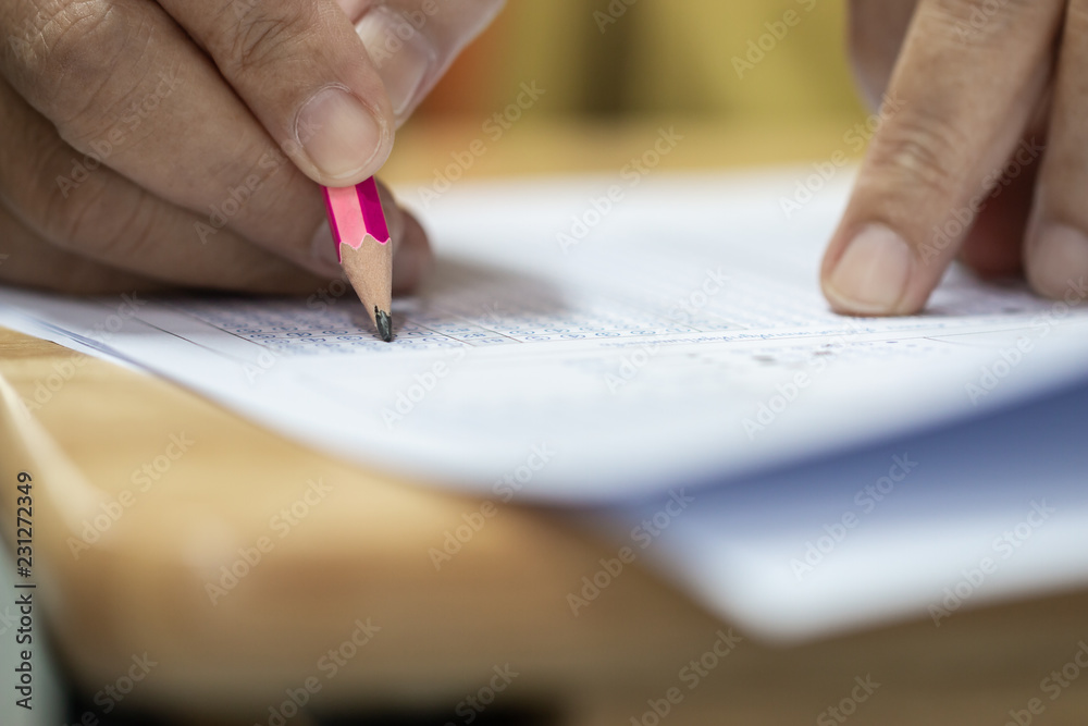 Education test concept : Hands student holding pen for testing exams ...