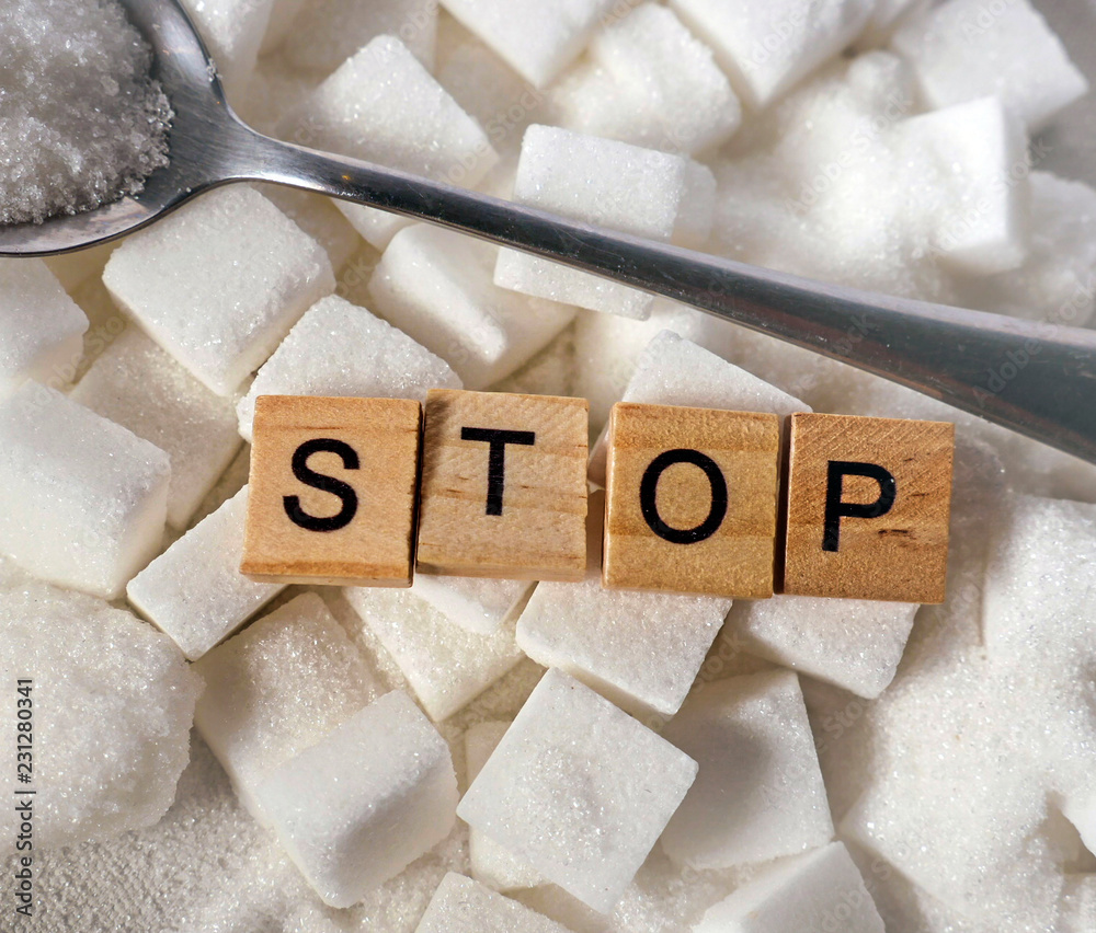 h pile of white sugar cubes and stop word in block letters as advise on ...