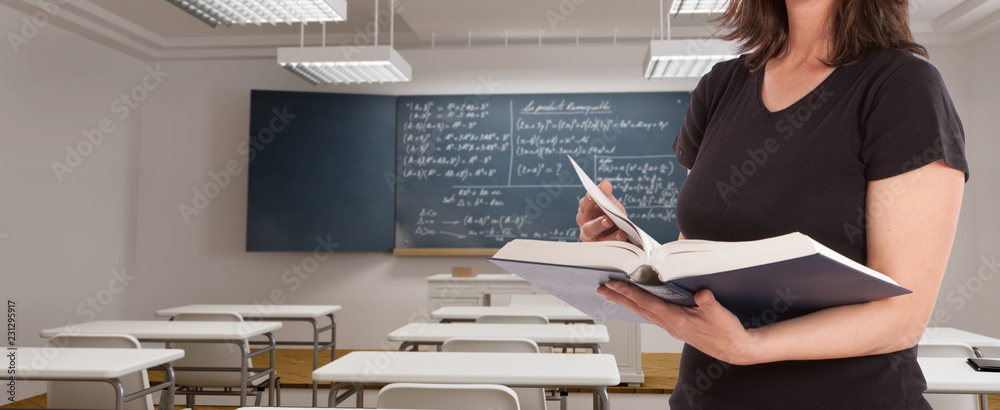 Teacher in a classroom Stock Photo | Adobe Stock