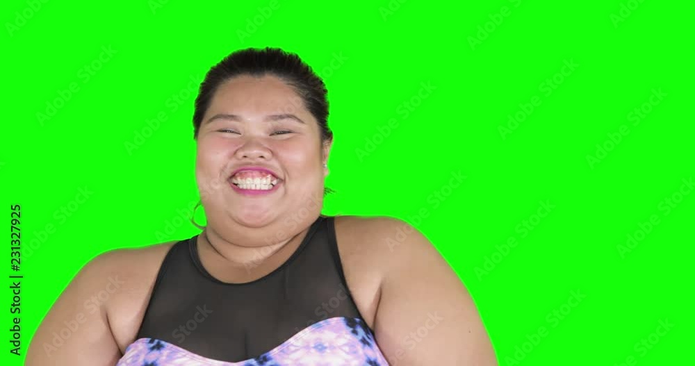 Happy overweight woman laughing in the studio. Shot in 4k resolution ...