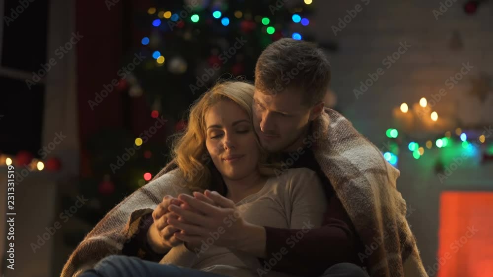 Tender couple spending X-mas together, man cupping ladies hands and ...