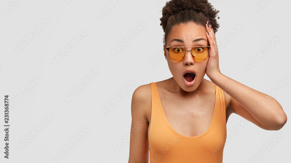 No way, its shocking! Surprised black woman with curly hair, wears ...