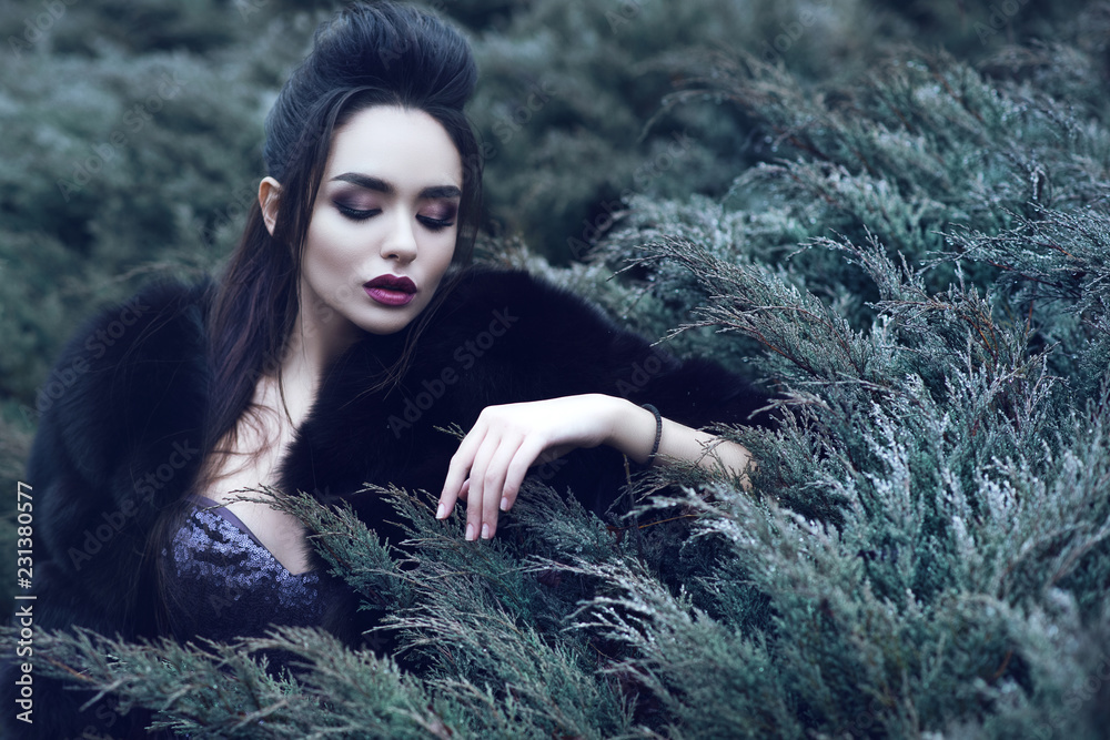 Young beautiful lady with perfect provocative make up and combed ...