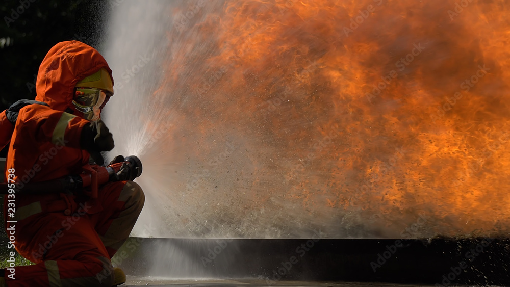 Foto de Fireman using fire hydrant to stop a flame. They use many ...