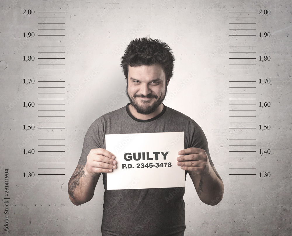 Caught guilty man with ID signs on his hand. Stock Photo | Adobe Stock