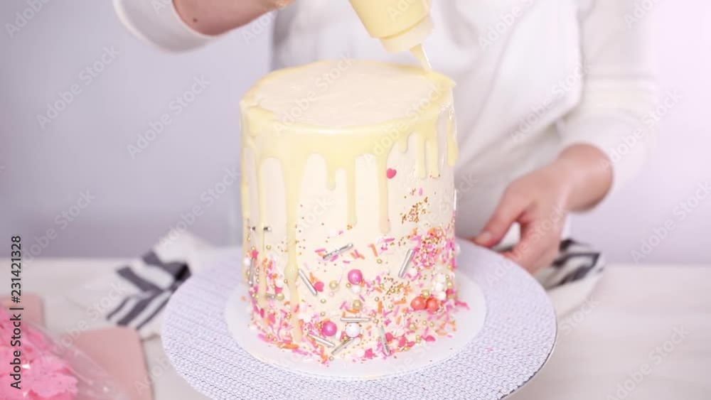 Step by step. Dripping a white chocolate ganache on birthday cake with ...
