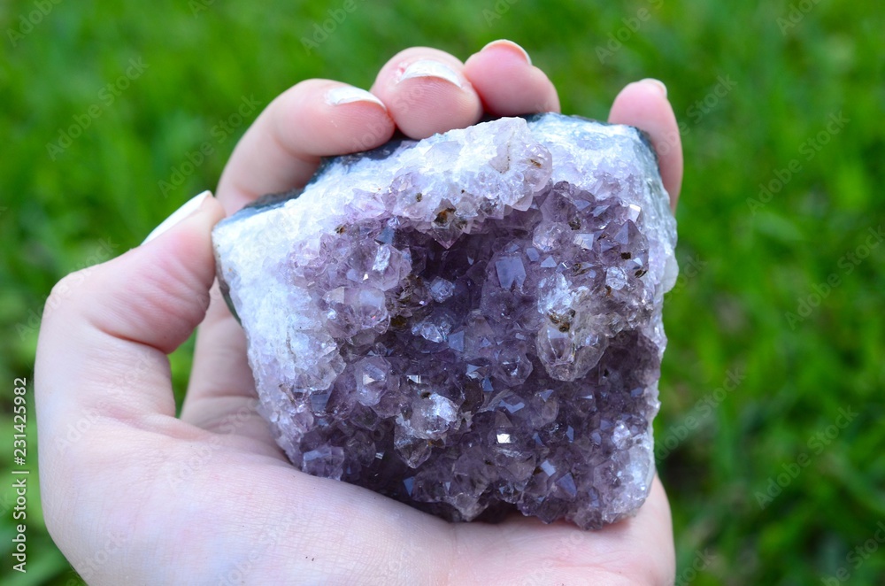 Natural Amethyst out in nature, in the grass. Spring time colors ...