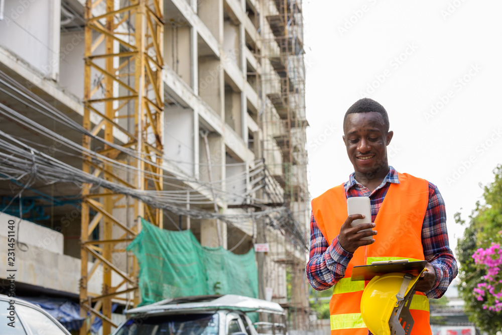 Young happy black African man construction worker smiling and us Stock ...