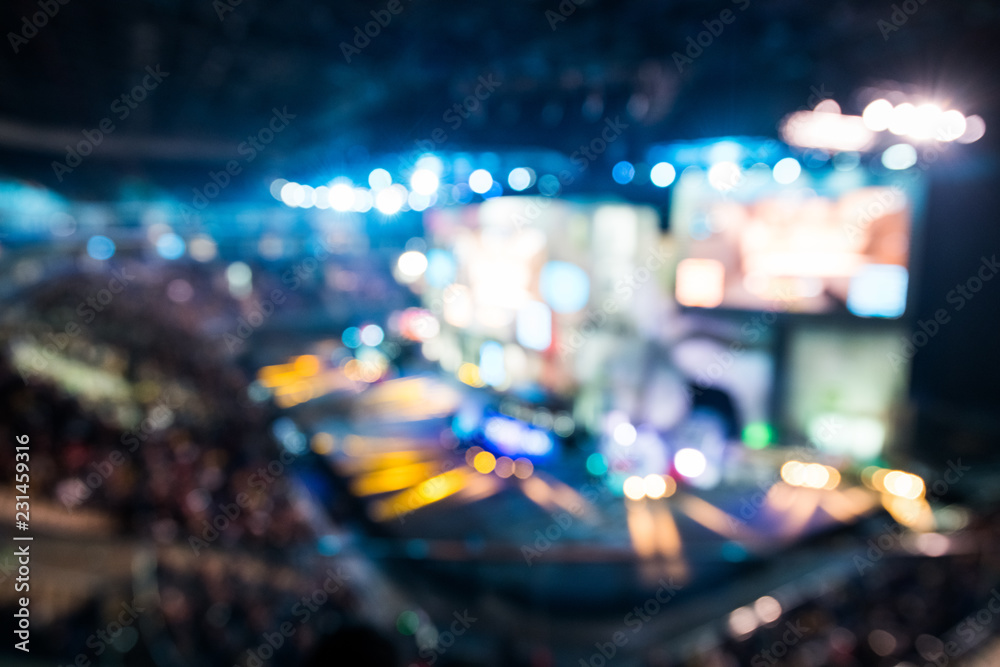 Blurred background of esports event at big arena with a lot of lights ...