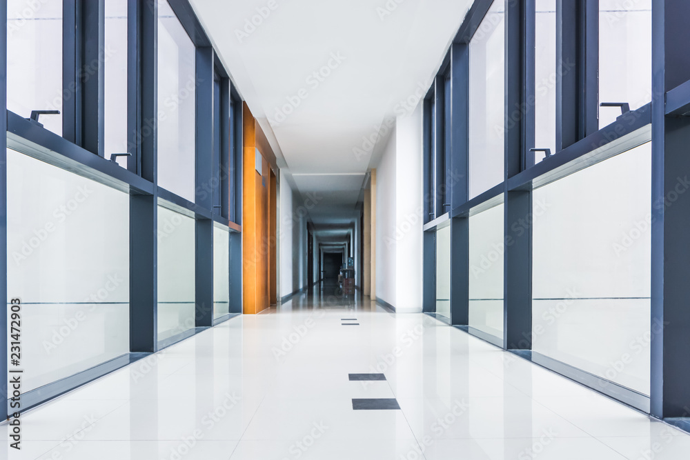 Illuminated long corridor in modern office building Stock Photo | Adobe ...