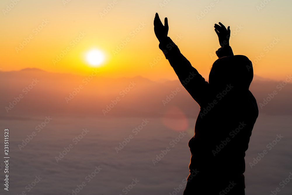 Girl silhouette raising hands in sunset light., Crucifix, Symbol of ...