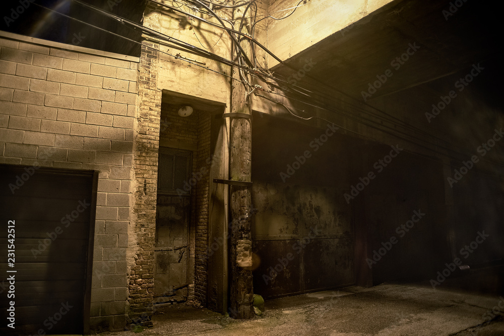 Dark and scary downtown urban city street corner alley with an eerie ...