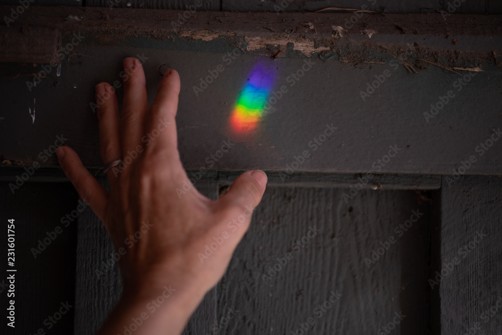 Rainbow prism cast on barn door. Stock Photo | Adobe Stock