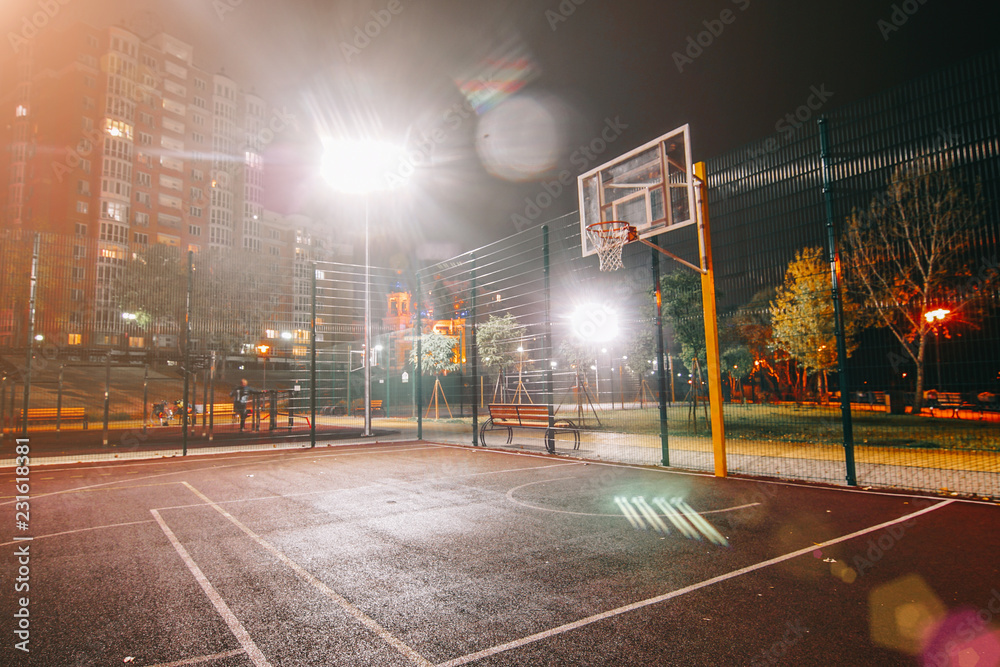 Illuminated basketball playground with red pavement, modern new ...