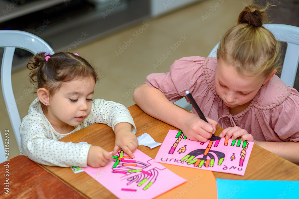 Kids Play With Stickers. Playing with stickers can help child on ...
